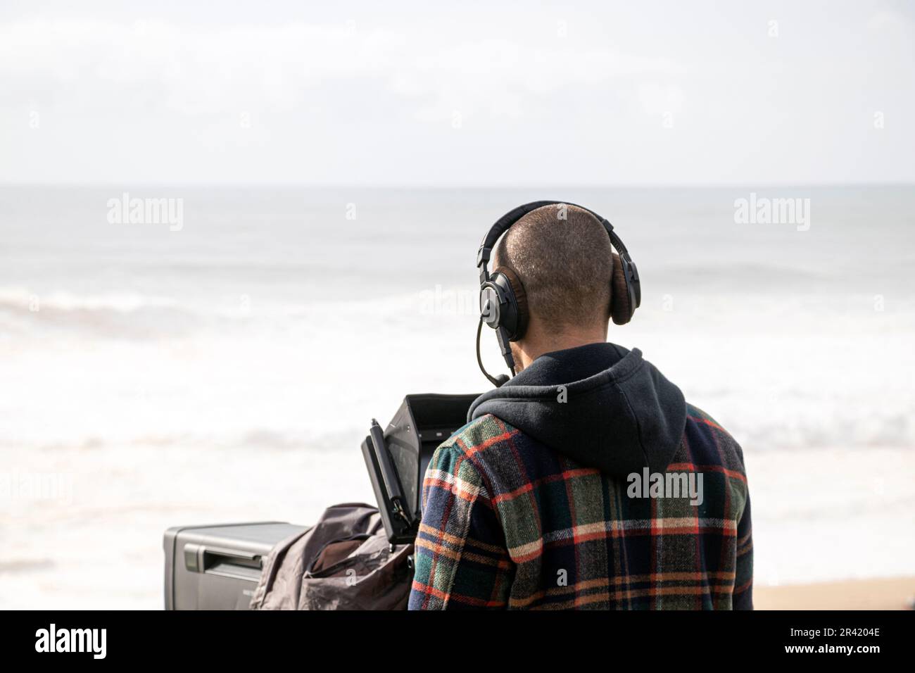 Professional Cameraman Filming by the Ocean Stock Photo - Alamy