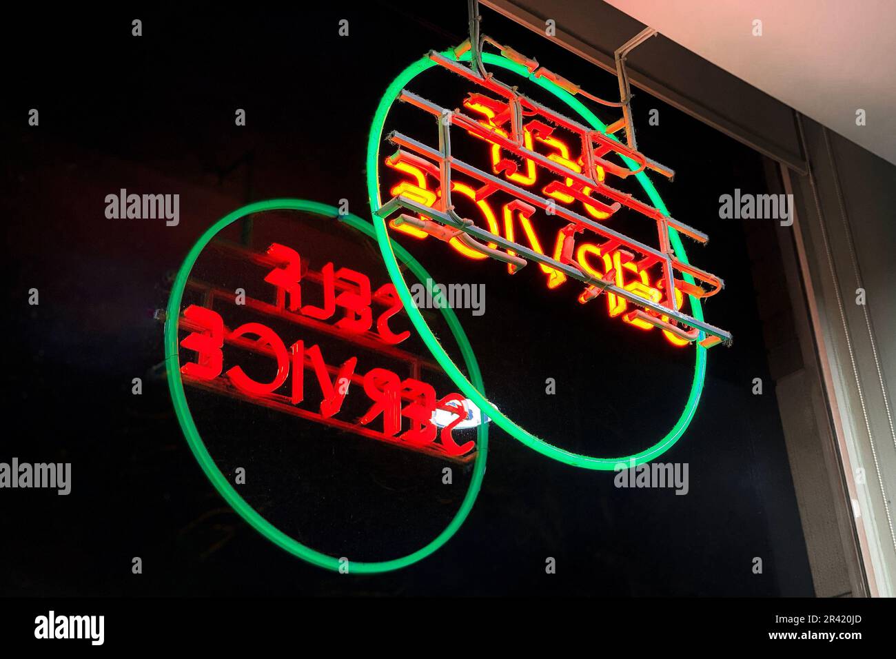 Retro Self-Service Neon Sign with Reflections in Window Stock Photo - Alamy