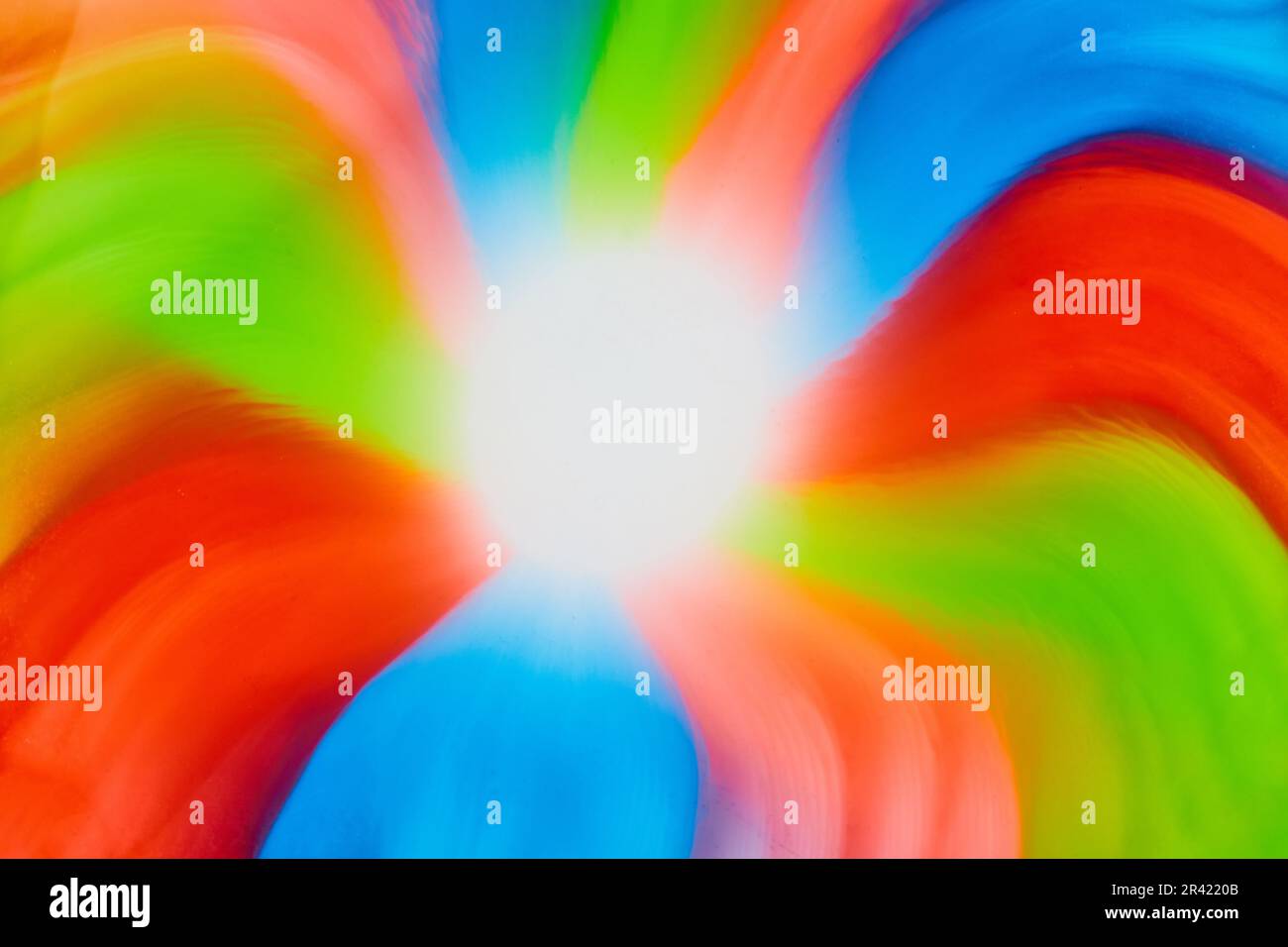 Abstract curved swirl of candy colors as skittles sugar mixes with ...
