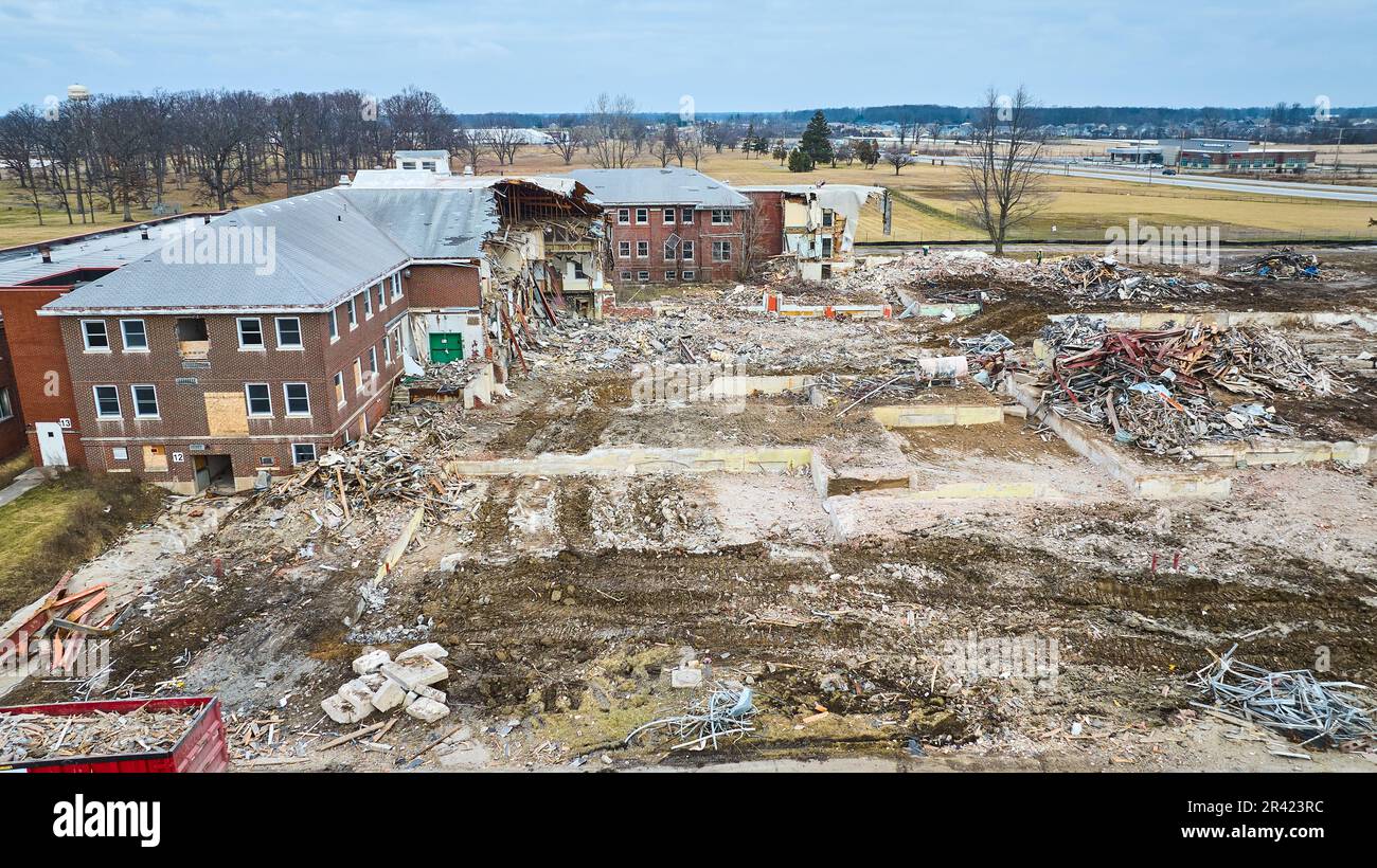 Destroyed building with boarded up windows and debris on the ground ...