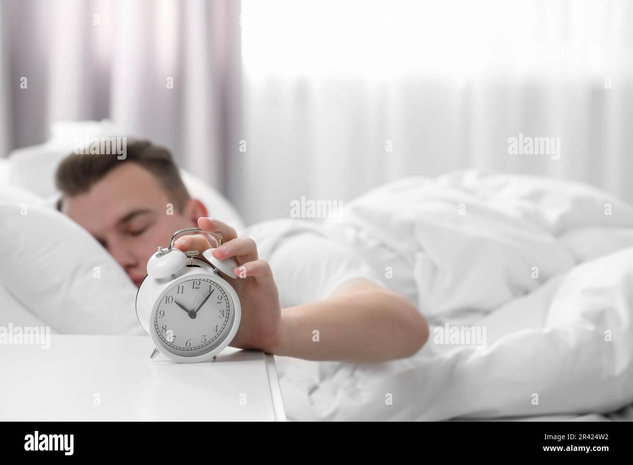 Man alarm clock switch off hi-res stock photography and images - Alamy