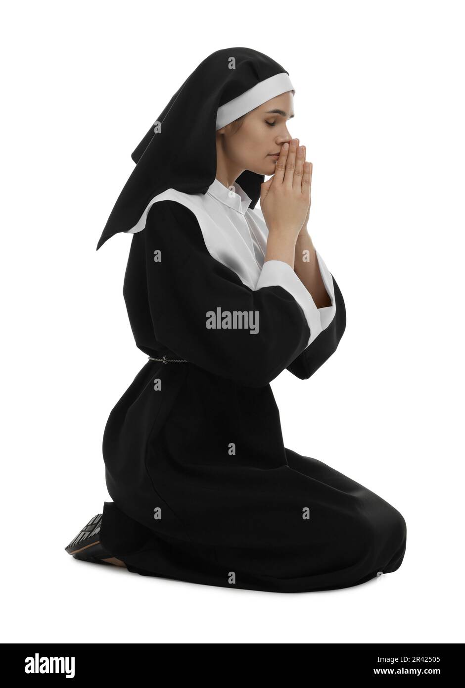 Nun with clasped hands praying to God on white background Stock Photo ...