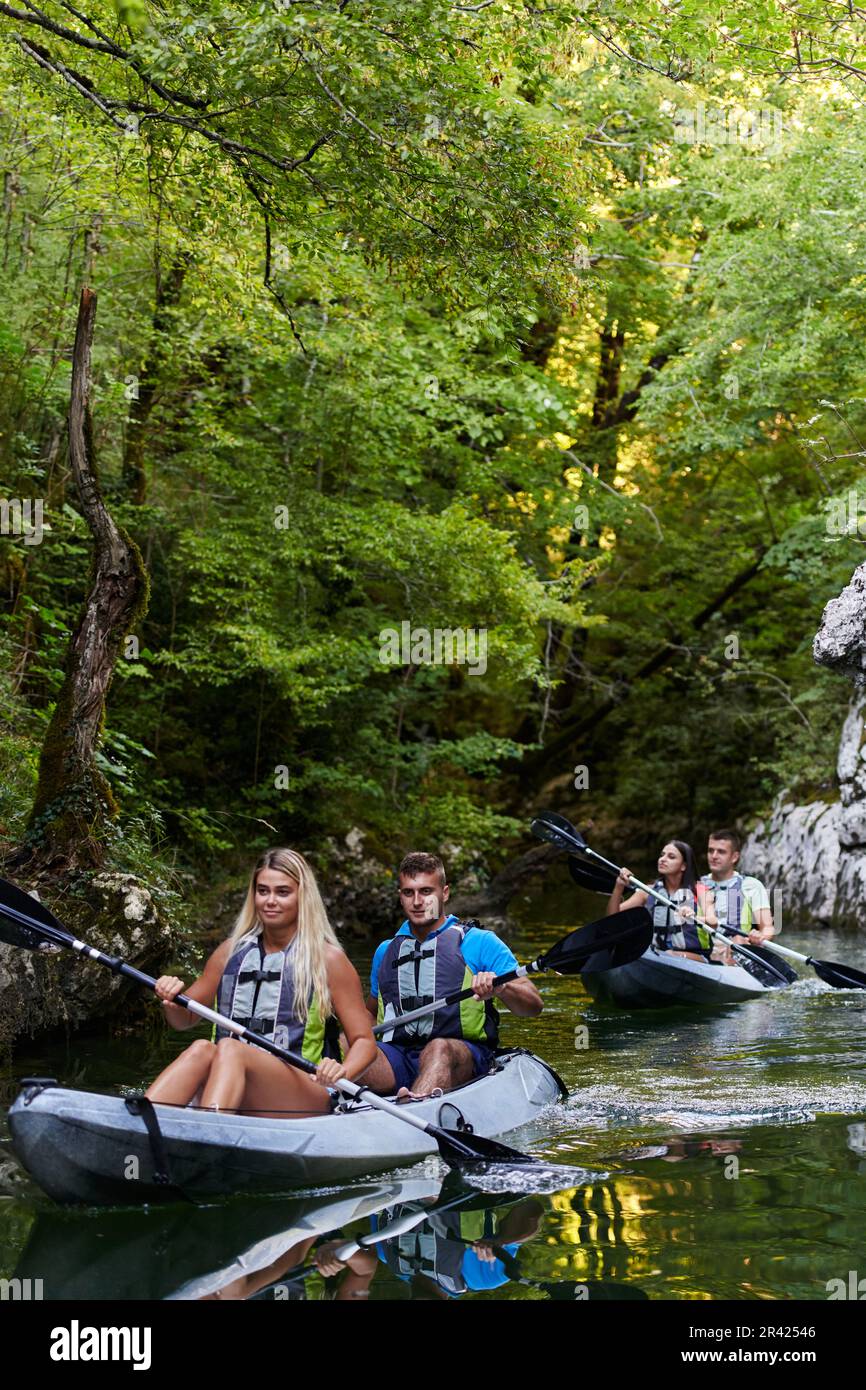 A group of friends enjoying having fun and kayaking while exploring the ...