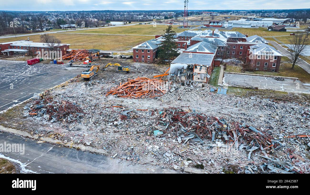 Drone aerial of deconstruction site of old abandoned hospital building ...