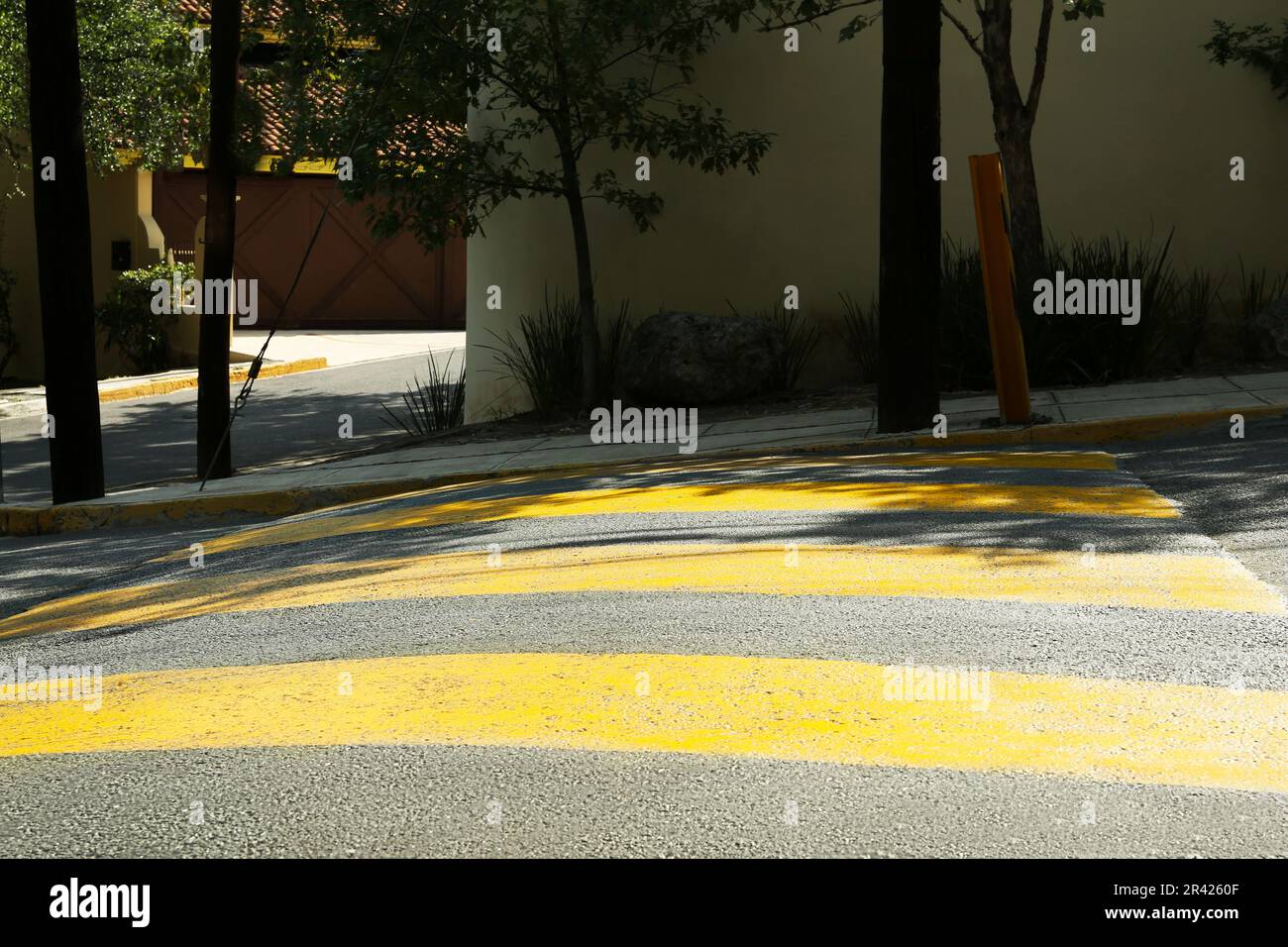 Speed bump on empty street. Road rules Stock Photo - Alamy