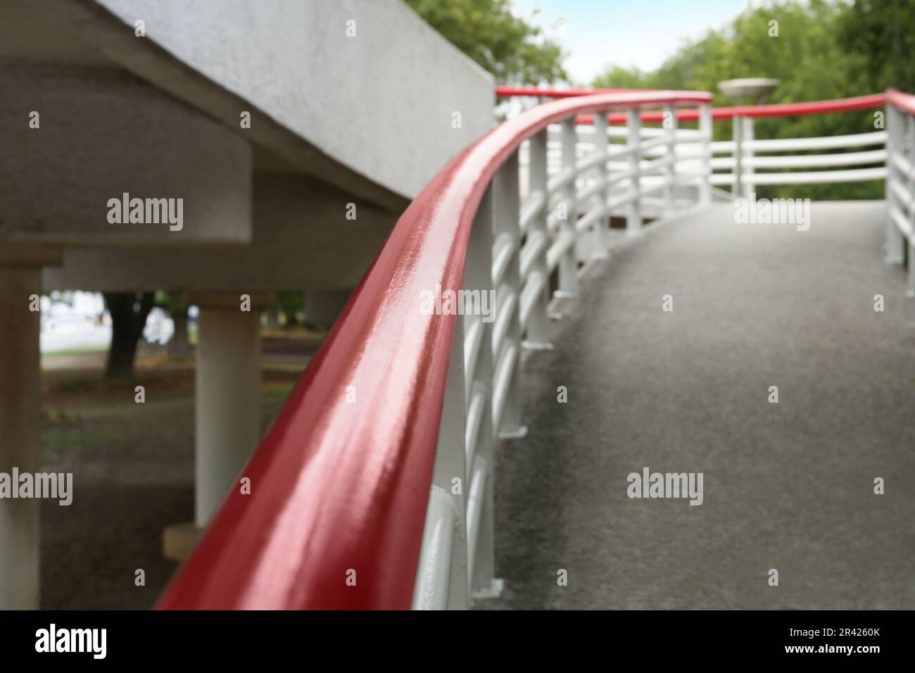 Ramp with red metal handrailings near trees outdoors Stock Photo - Alamy