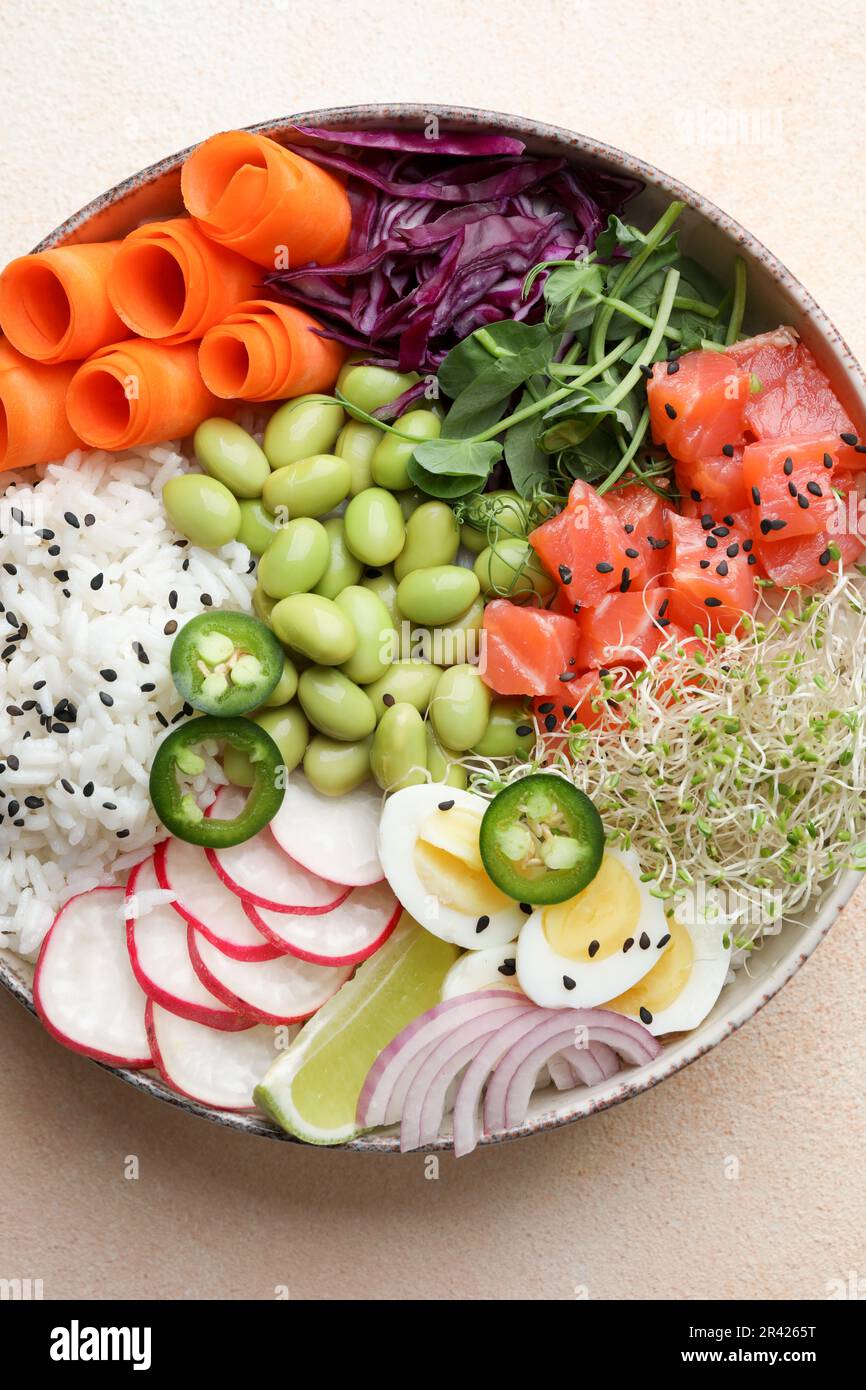 Delicious poke bowl with quail eggs, fish and edamame beans on light ...