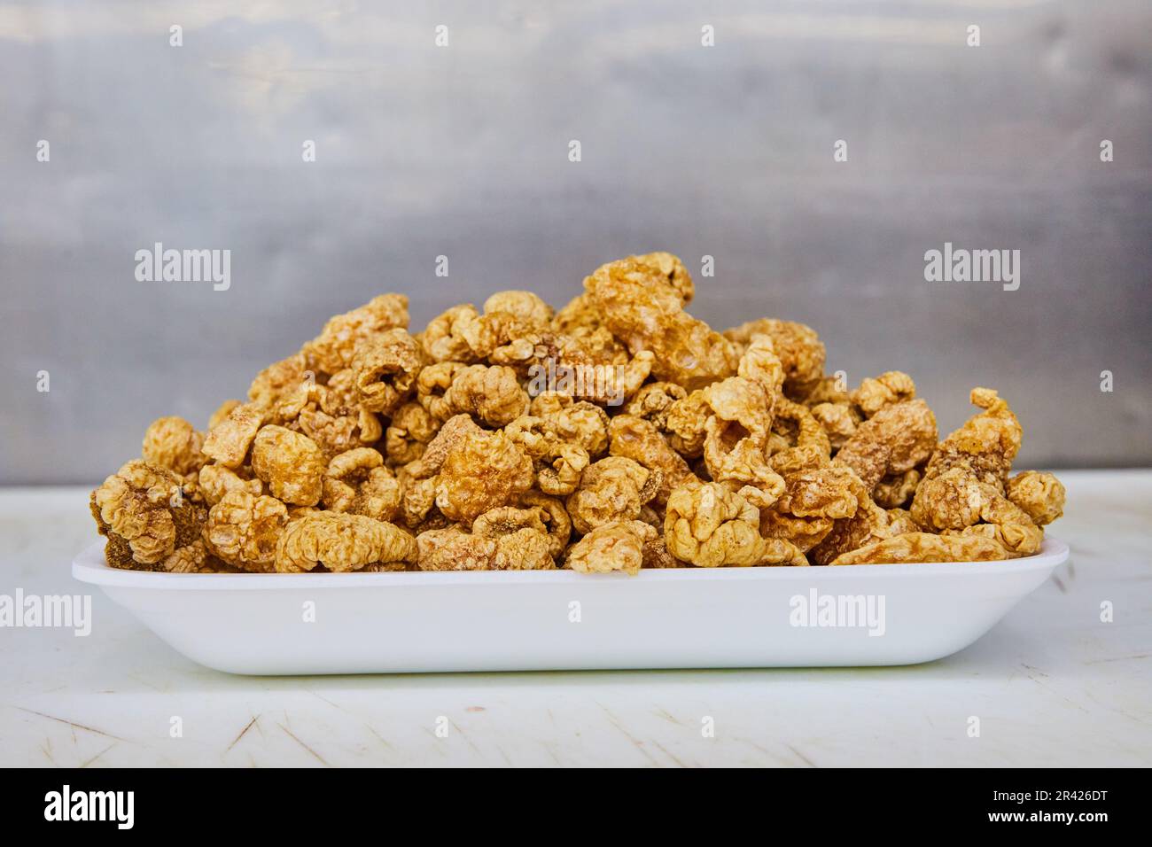 Chicharrones in white tray piled high Stock Photo - Alamy