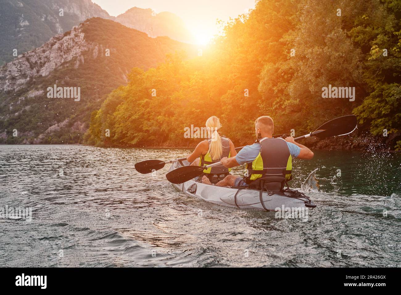 A group of friends enjoying fun and kayaking exploring the calm river ...