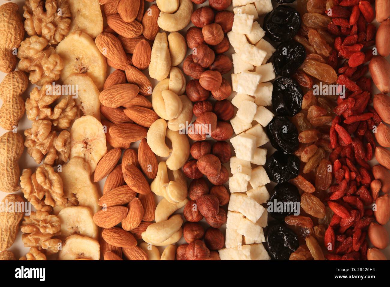 Different tasty nuts and dried fruits as background, top view Stock ...