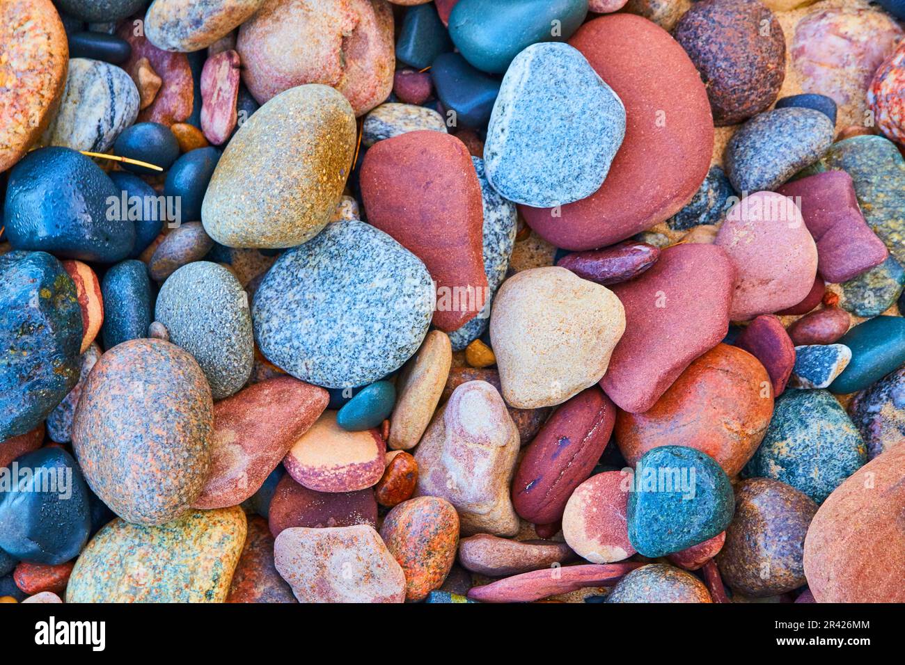 Collection of multiple colors of smooth stones rubbed smooth by lake ...