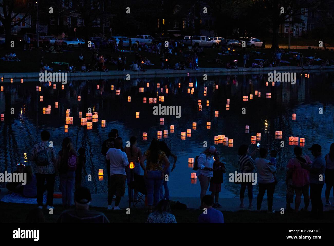 Lantern festival with people and lanterns floating on surface of water ...