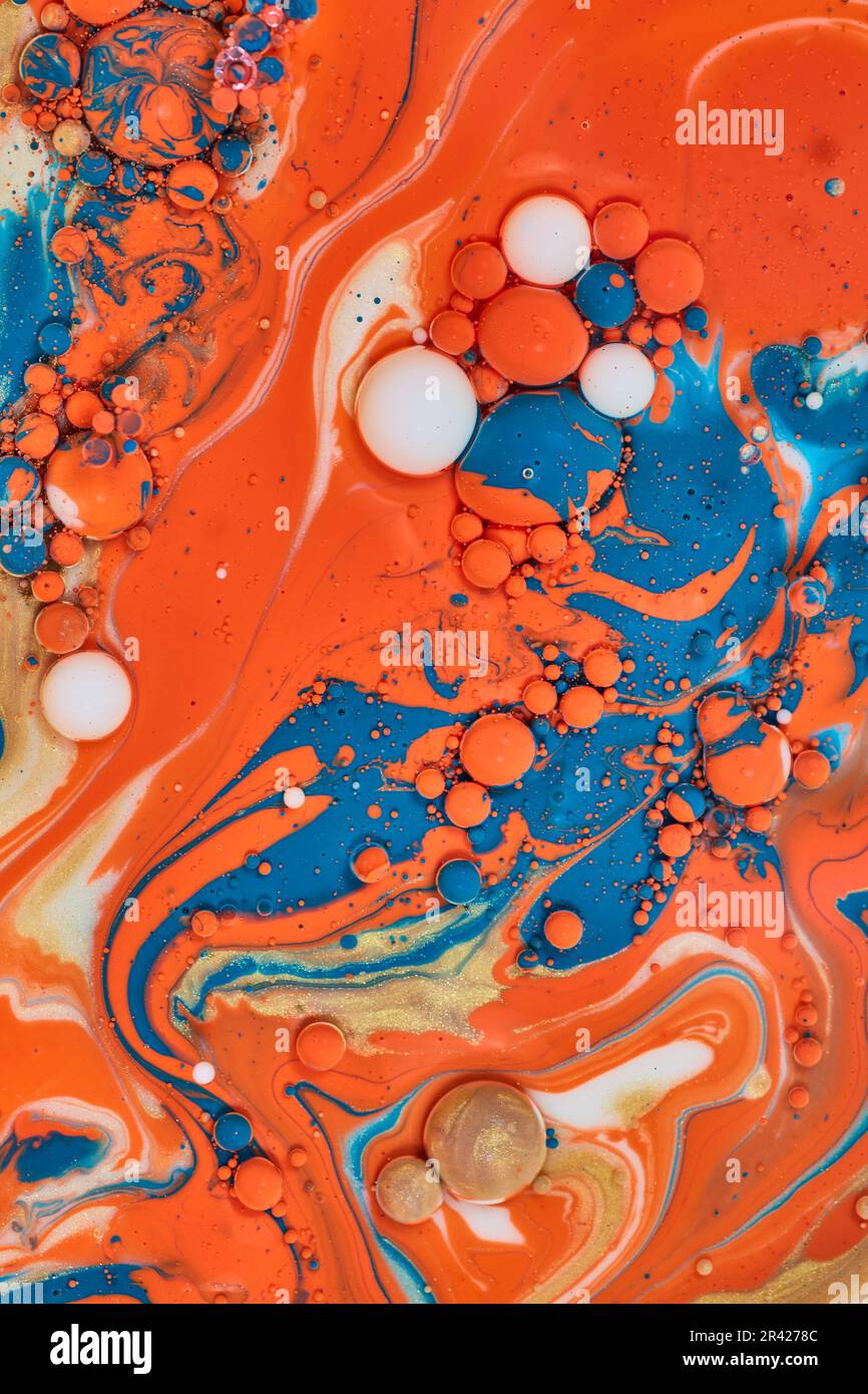 Vertical background asset of swirling blue gold white and orange paint ...
