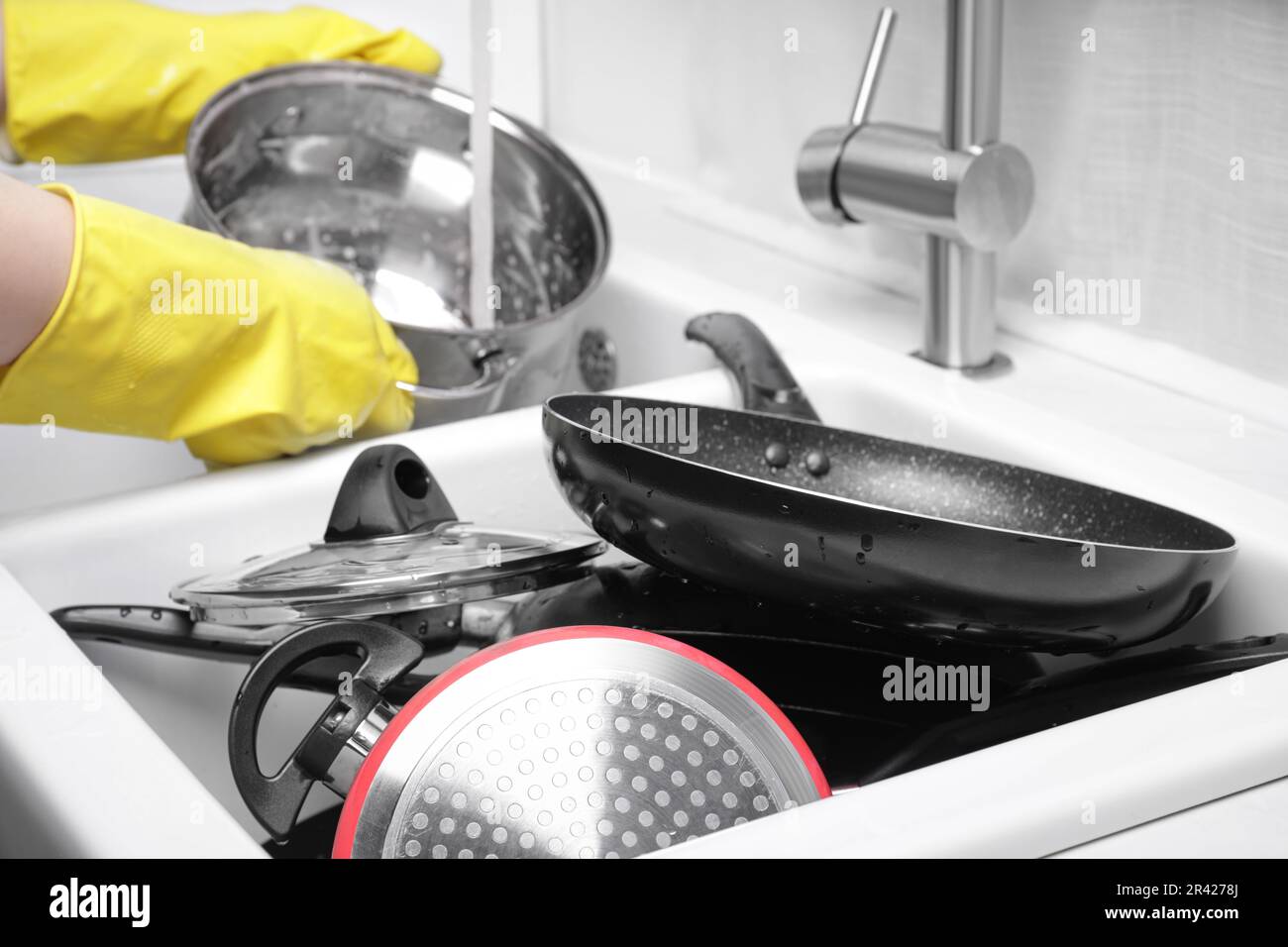 Woman washing pot in kitchen sink, focus on dirty kitchenware Stock ...