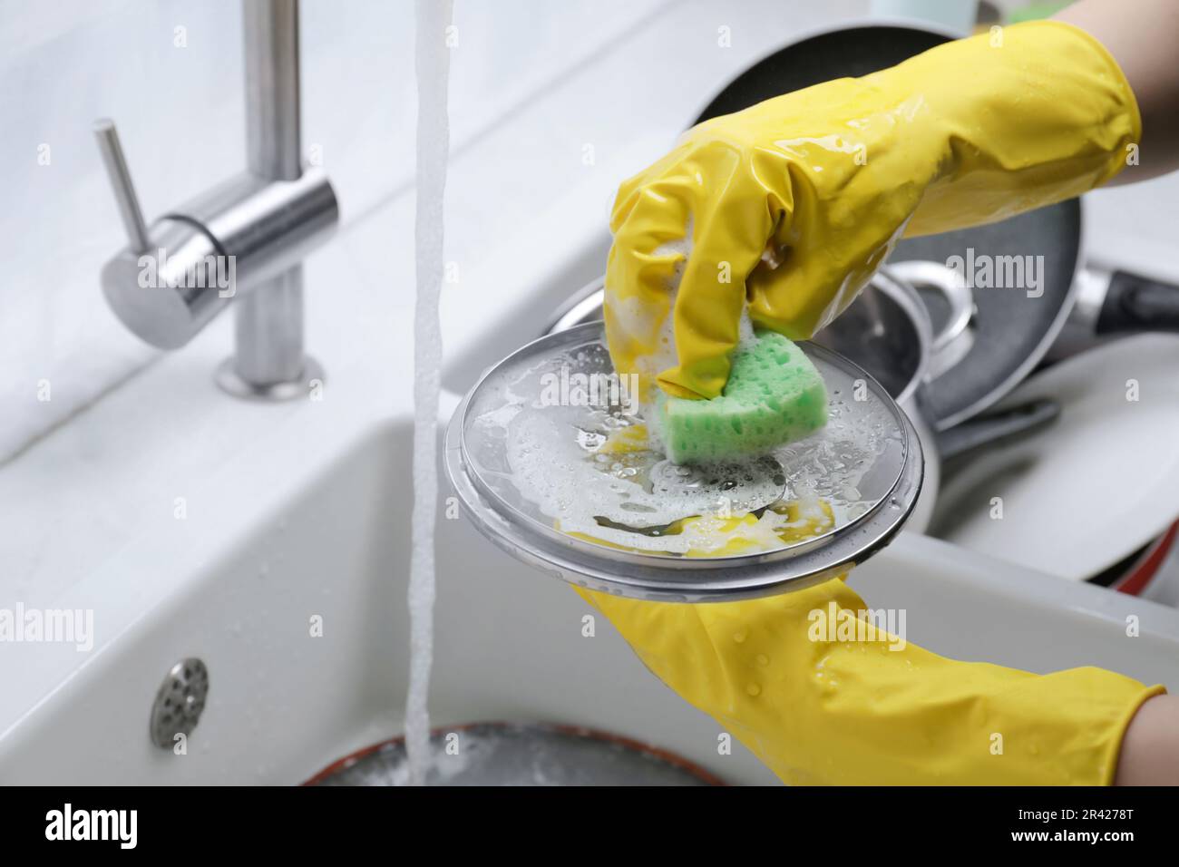 Woman washing dirty dishes in kitchen sink, closeup Stock Photo - Alamy