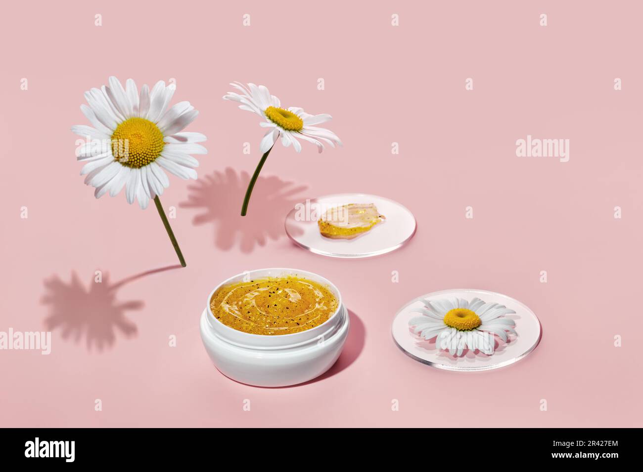 Gel cosmetic product with particles in petri dish on pink background ...