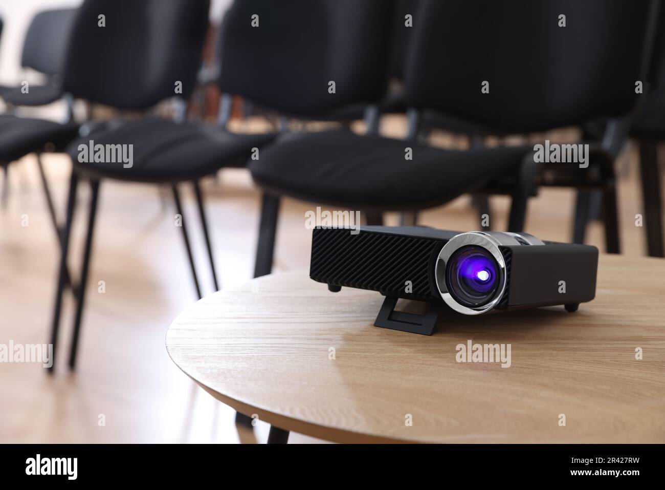 Modern video projector on table in conference room Stock Photo - Alamy