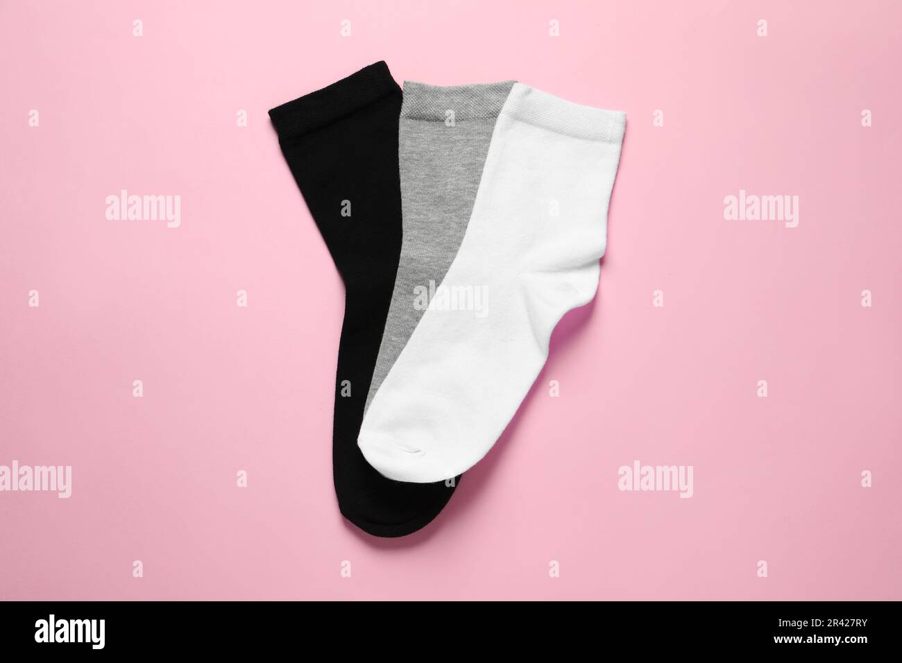 Different socks on pink background, flat lay Stock Photo - Alamy