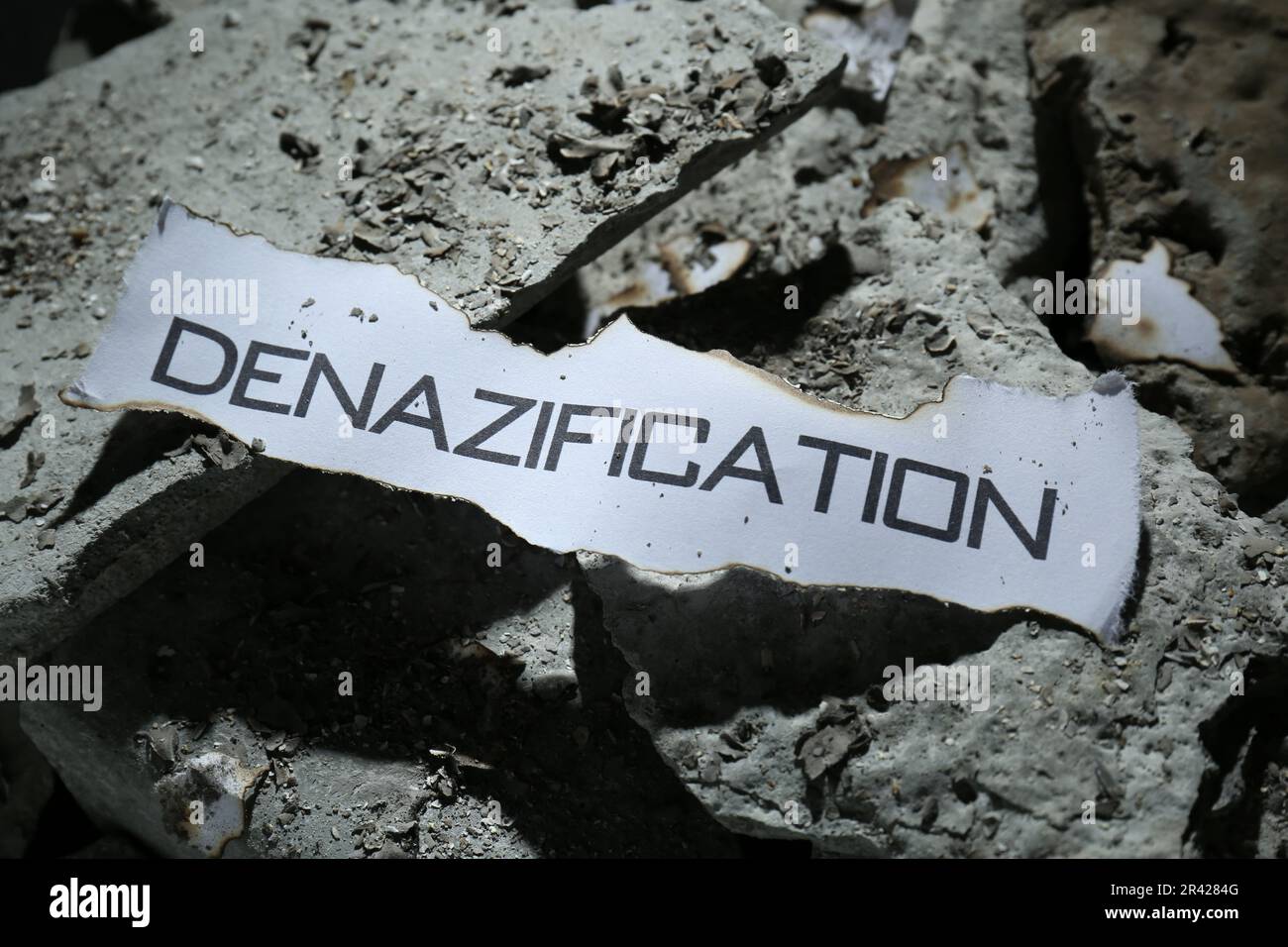 Paper with word Denazification on pieces of concrete, closeup Stock ...