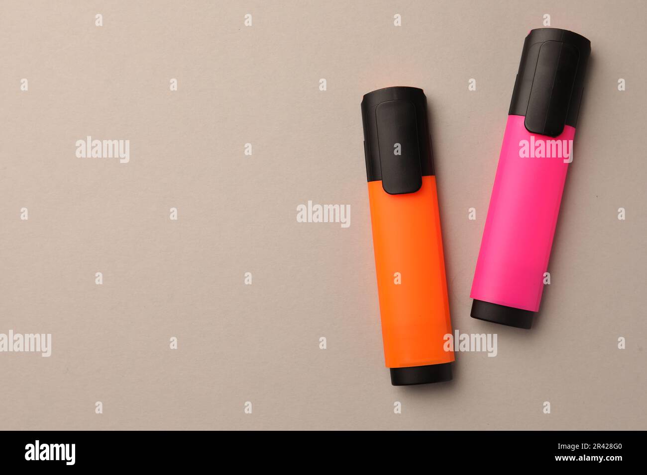 Bright color markers on light grey background, flat lay. Space for text ...