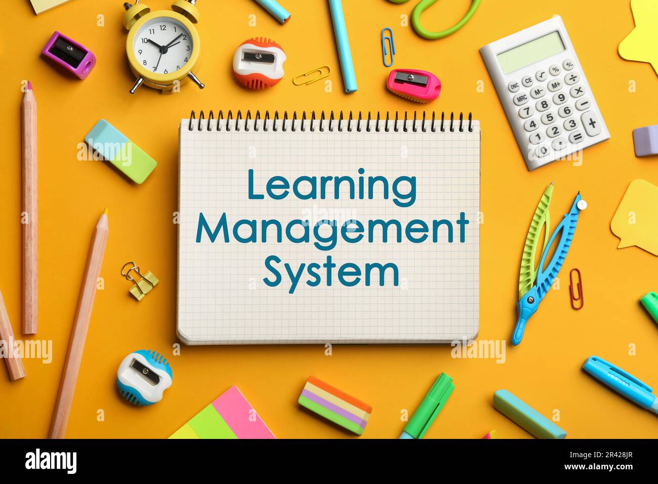 Notebook with text Learning Management System and stationery on yellow ...