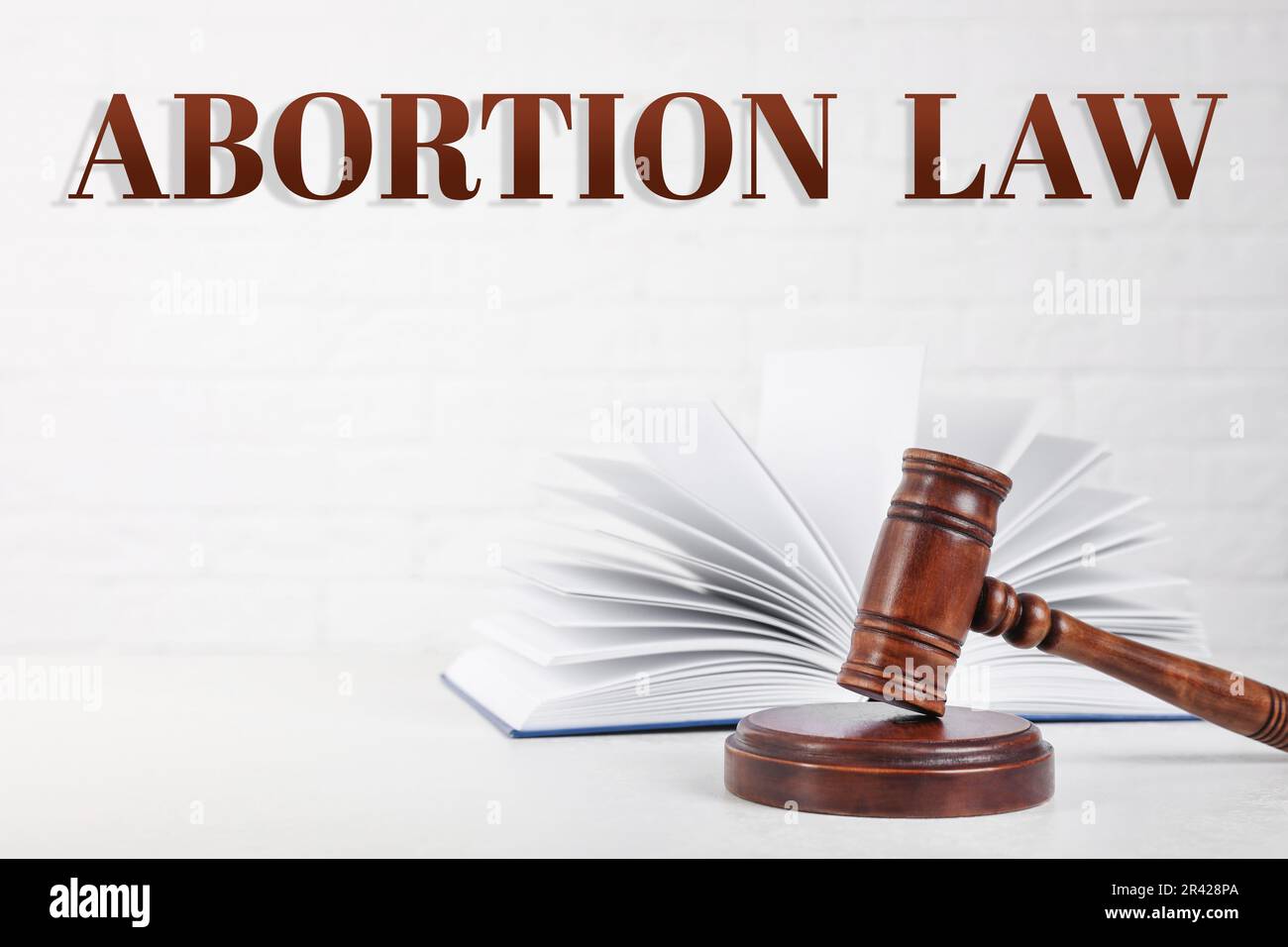 Abortion law. Gavel and book on table against white background Stock ...