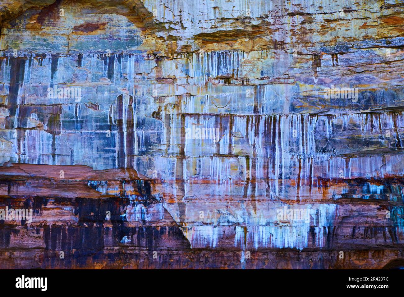 Flat stone walls of pictured rocks with white and red dripping painted ...