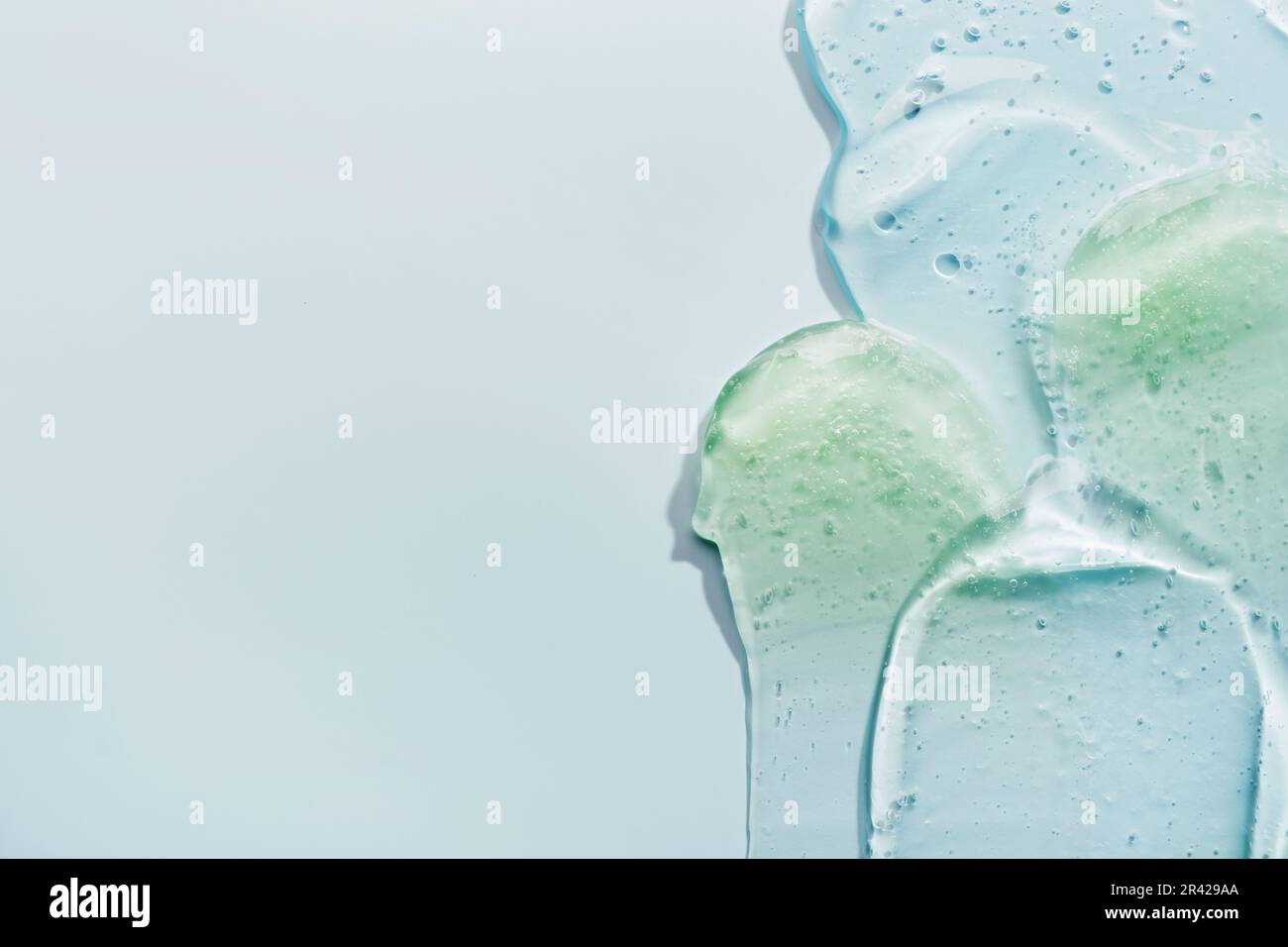 Liquid abstract cosmetic gel smears on blue background. Smear of ...