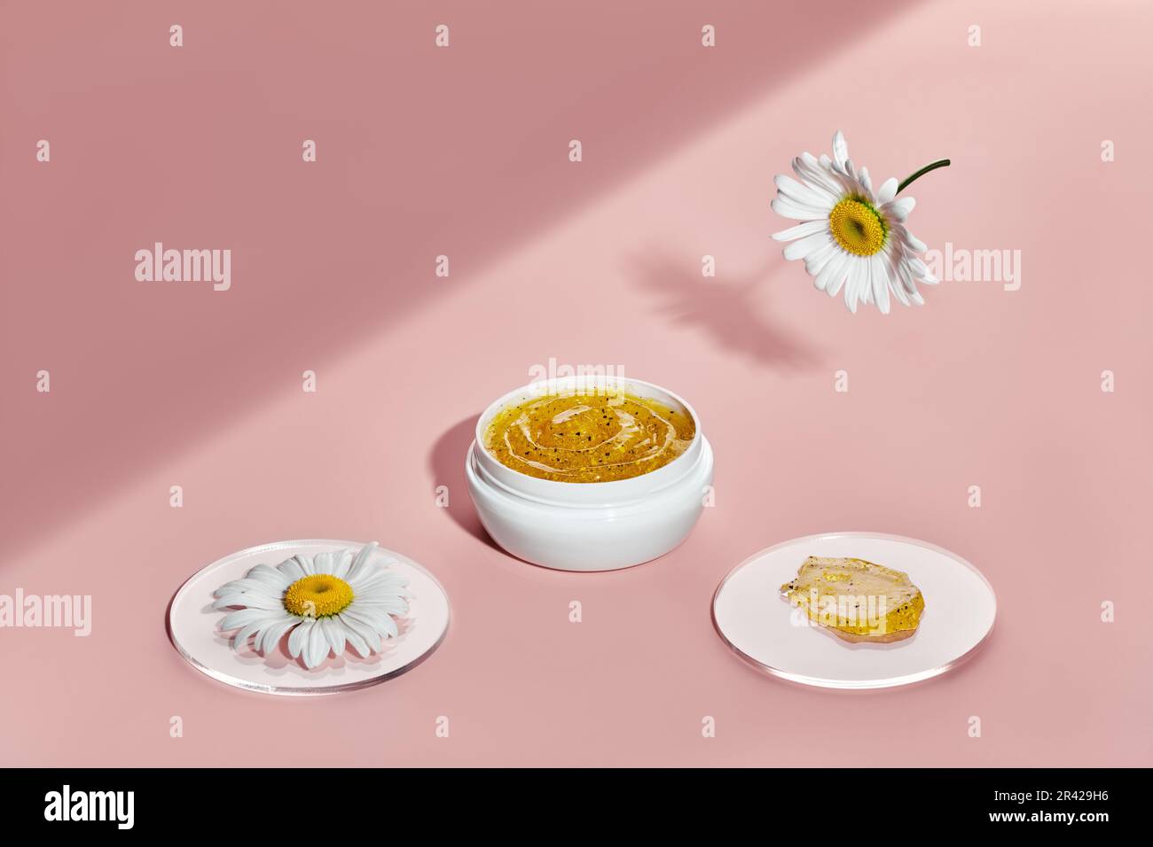 Gel cosmetic product with particles in petri dish on pink background ...