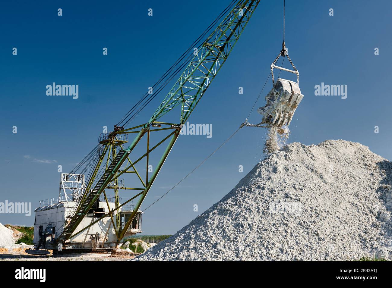 Walking excavator in process of chalk mining in open quarry Stock Photo ...