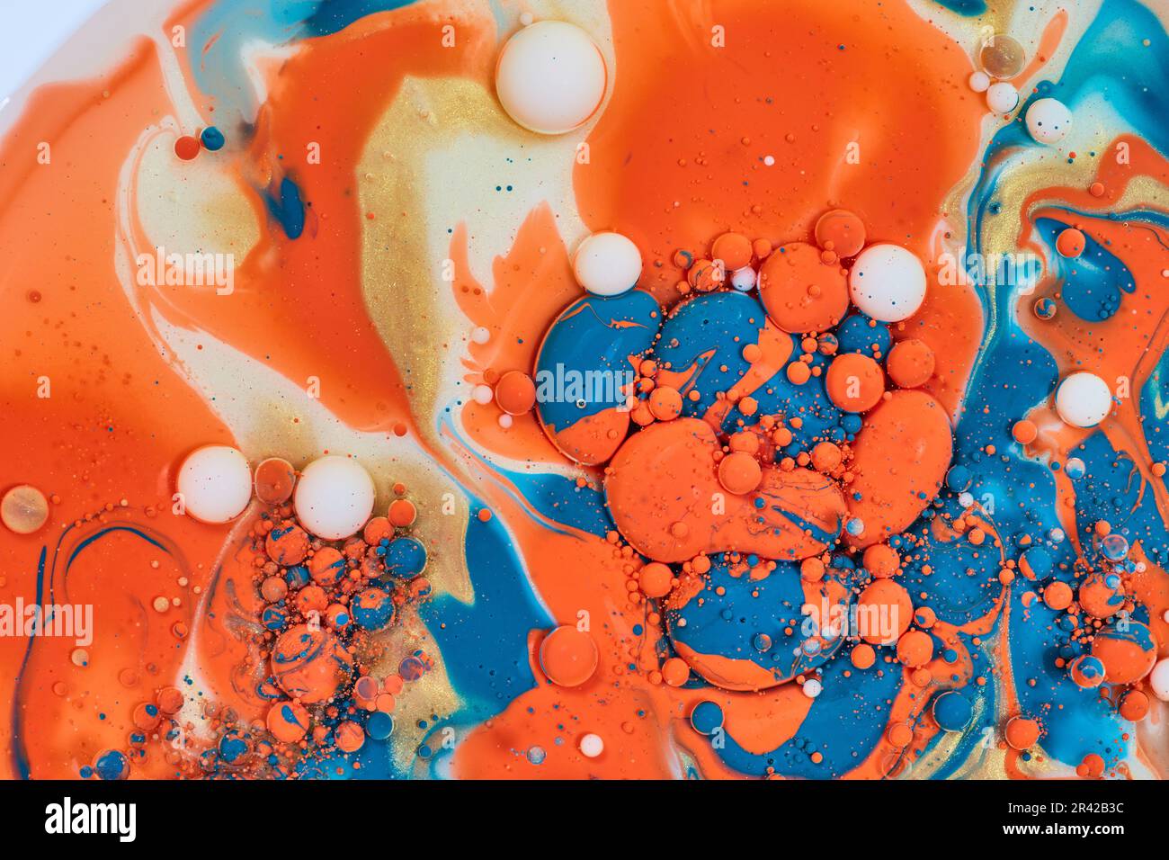 Horizontal abstract dancing of oil spill of golden cream mixing with ...