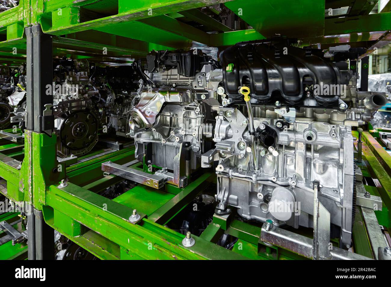 Car internal combustion engines stand on racks in warehouse Stock Photo ...