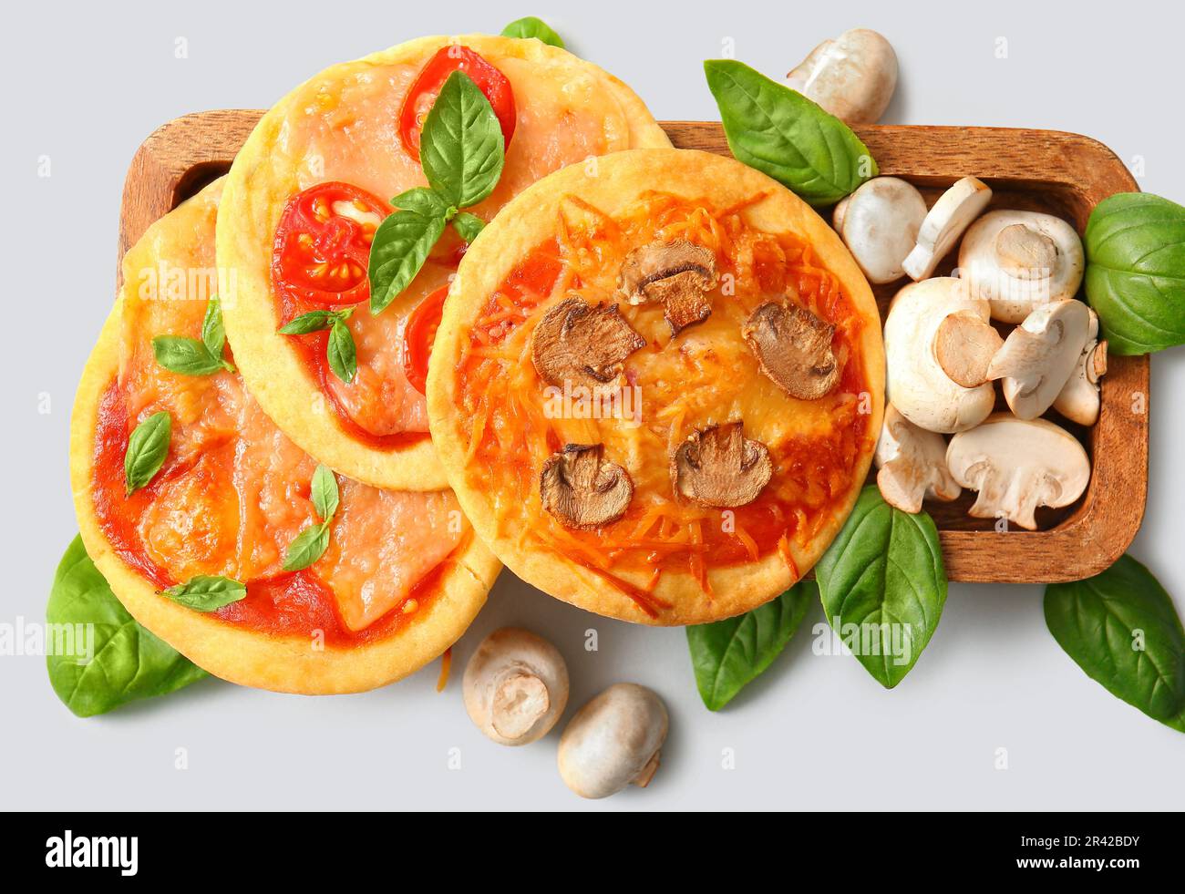 Board with different tasty mini pizzas on grey background Stock Photo ...
