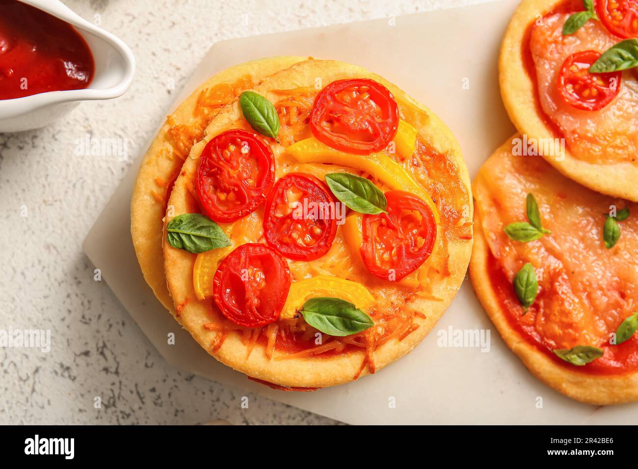 Board with different tasty mini pizzas on white background Stock Photo ...