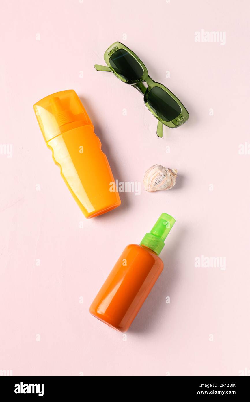 Bottles of sunscreen cream and sunglasses on white background Stock ...