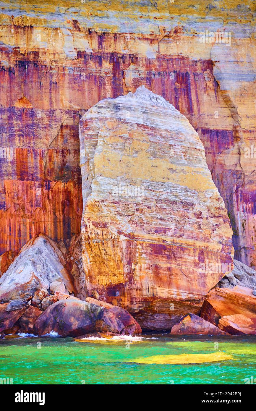 Sunny side of Pictured Rocks with mineral colors in stone cliff walls ...