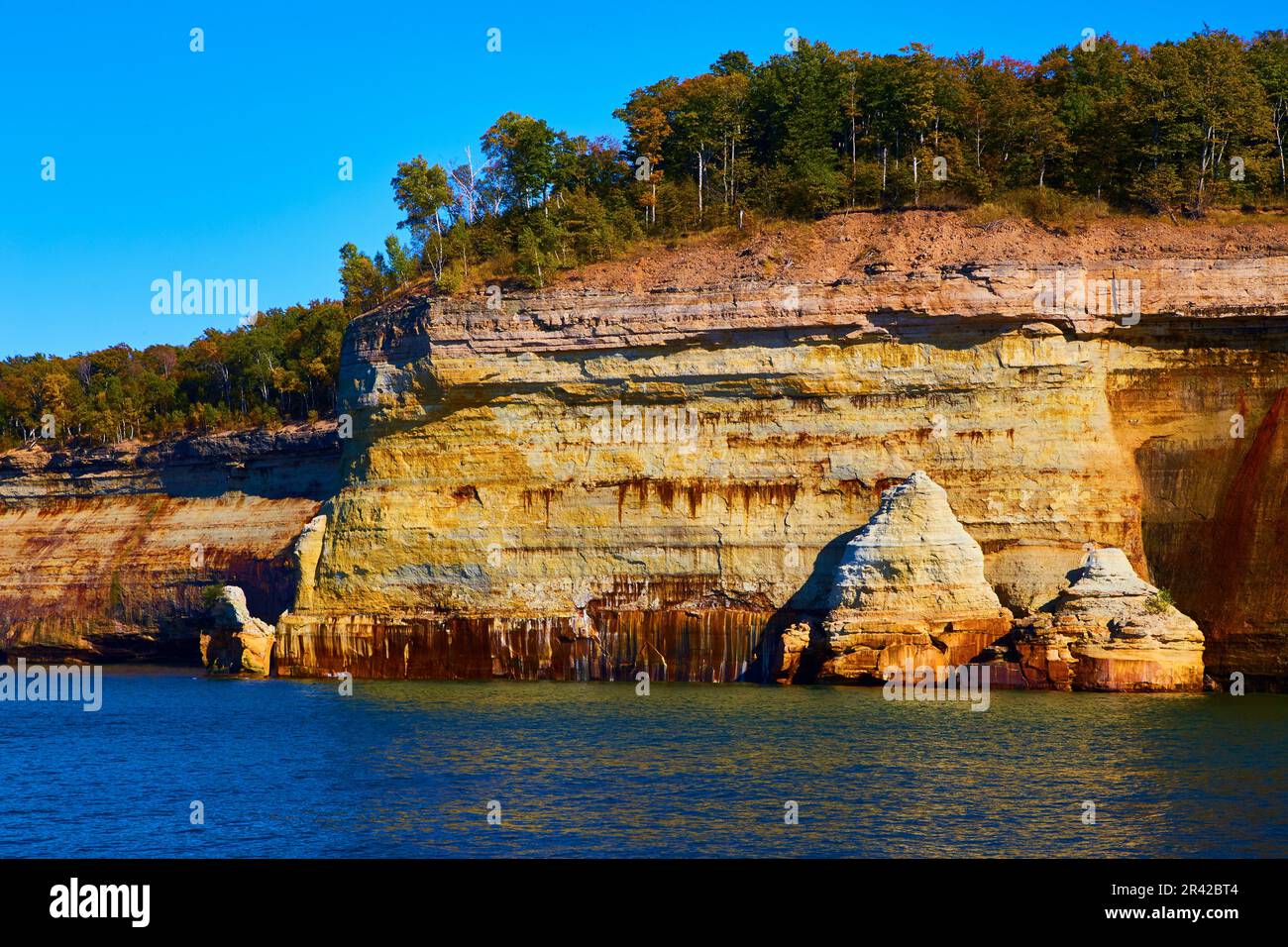 Pictured rocks national park with sheer cliff walls and tranquil lake ...