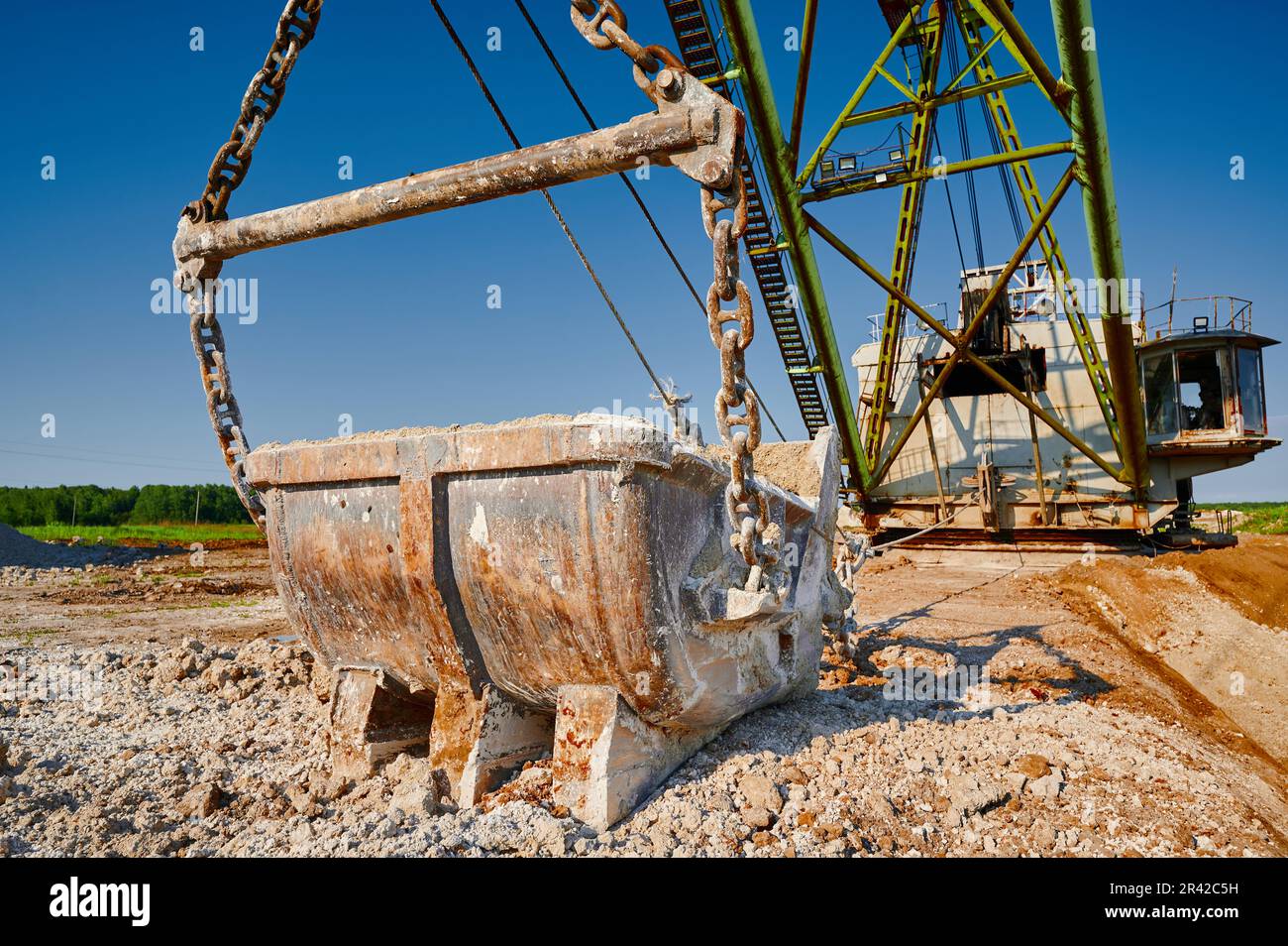 Bucket of old walking excavator digging calx in quarry Stock Photo - Alamy