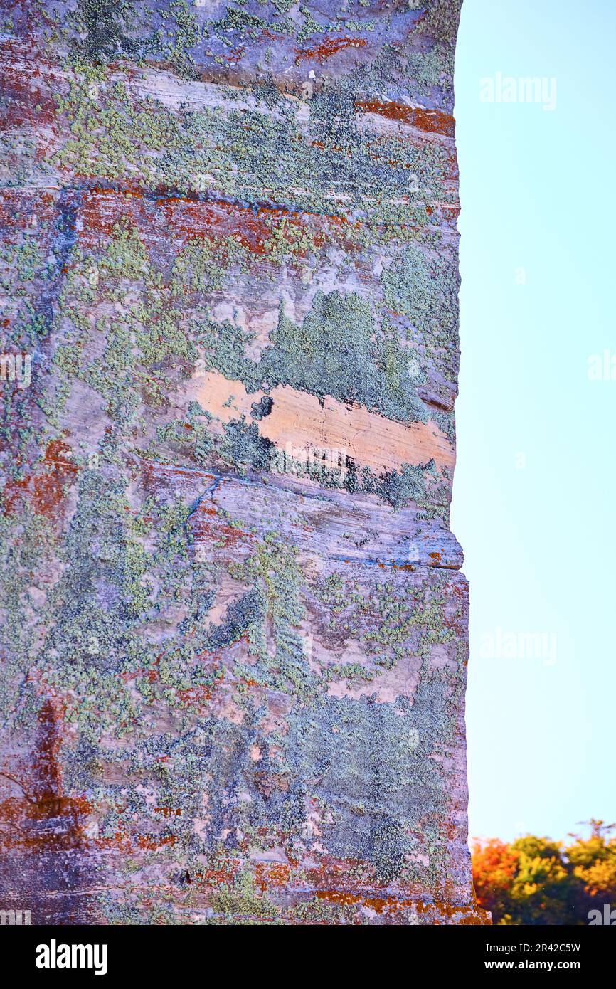 Bright blue sky against Pictured Rocks cliff wall with exposed minerals ...