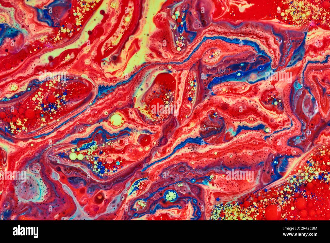 Scales of oil spill of abstract acrylic painting with red yellow blue ...