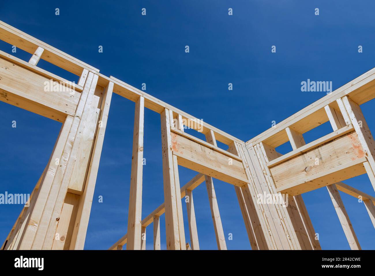 Frame house constructed from wooden beams sticks on new construction ...