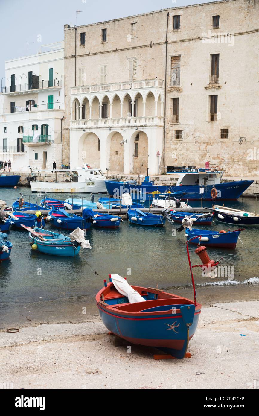 Blue and Red Wooden Boats moored in the harbour at Porto Antico ...