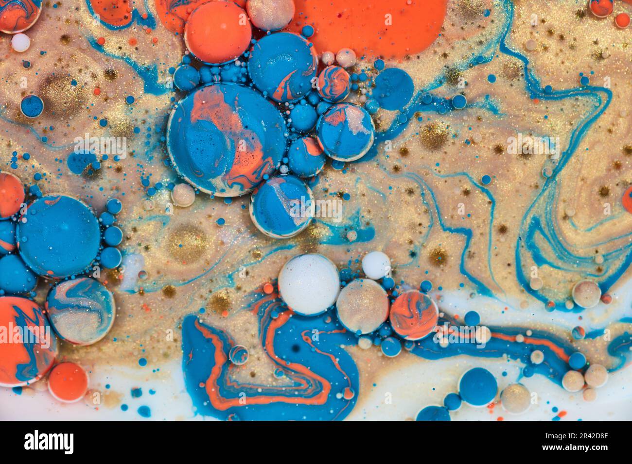 Spheres of cosmic eruption in sea of milk and oil and acrylic paint in ...