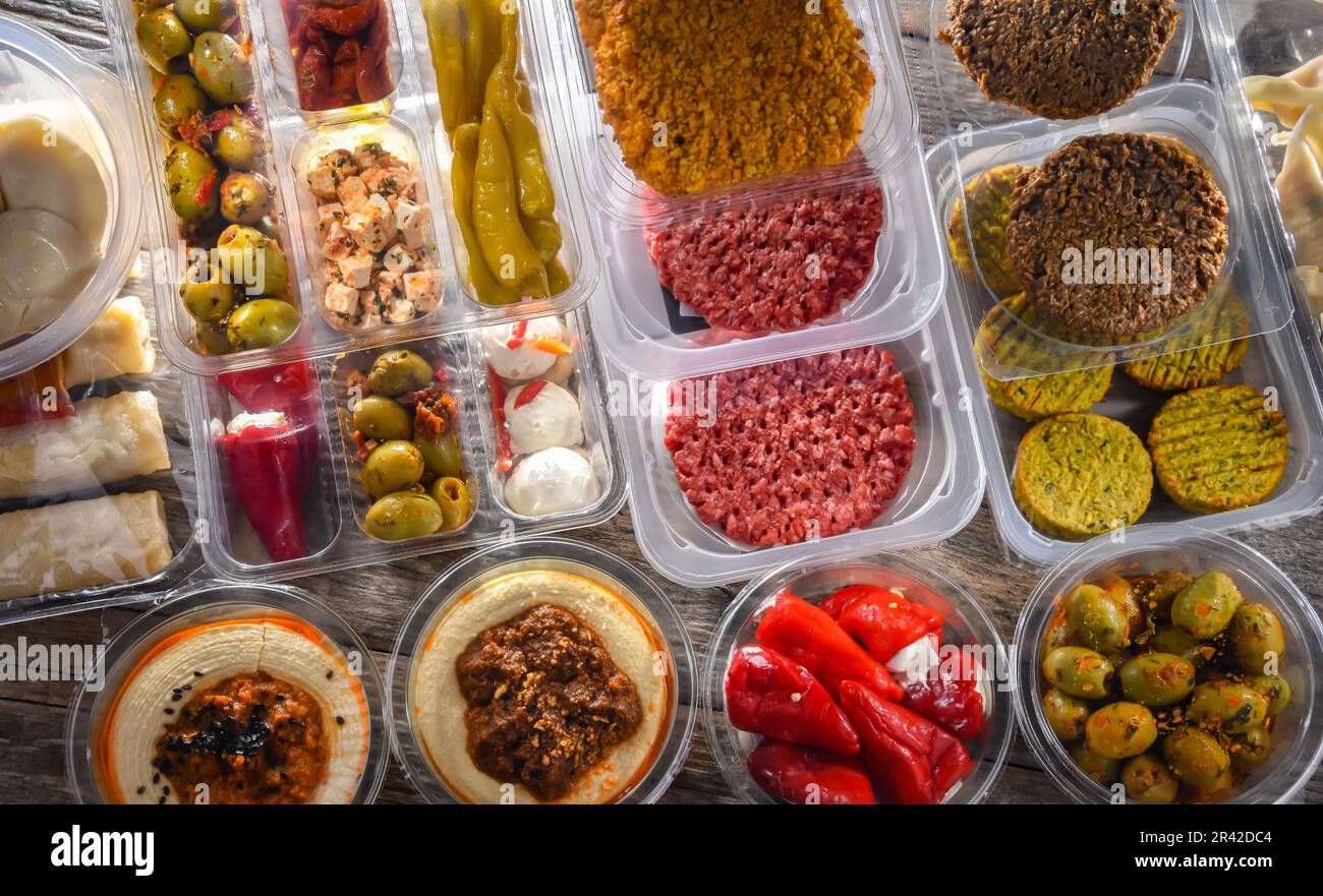 A display of a variety of prepackaged food products in plastic boxes ...