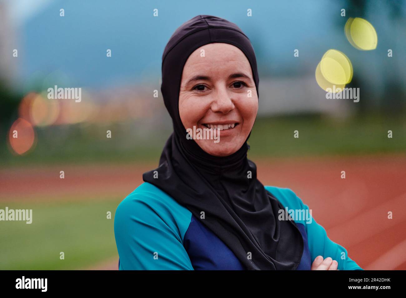 A Muslim woman with a burqa, an Islamic sportswoman resting after a ...