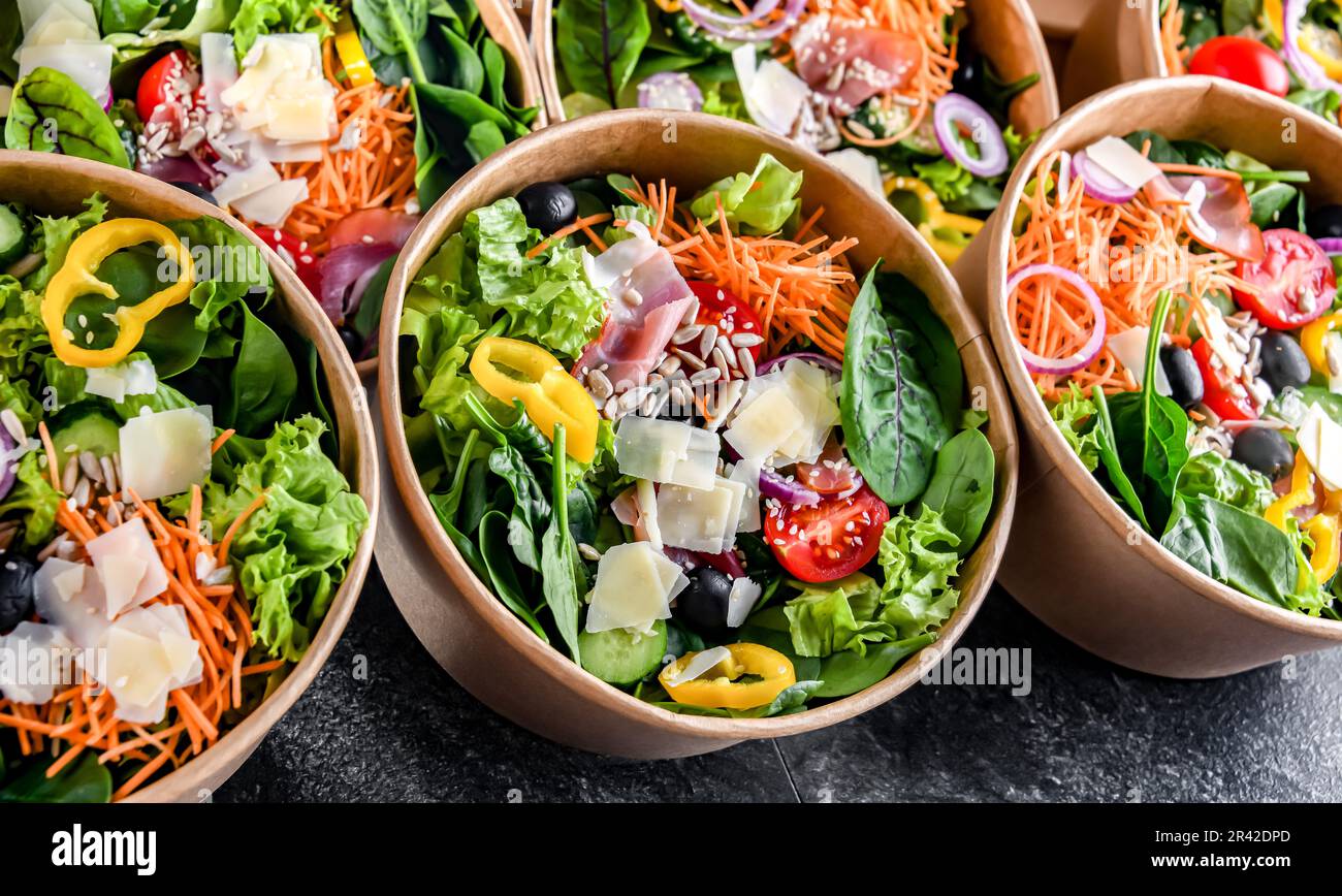 Round paper boxes with pre-packaged vegetable salads ready for sale ...