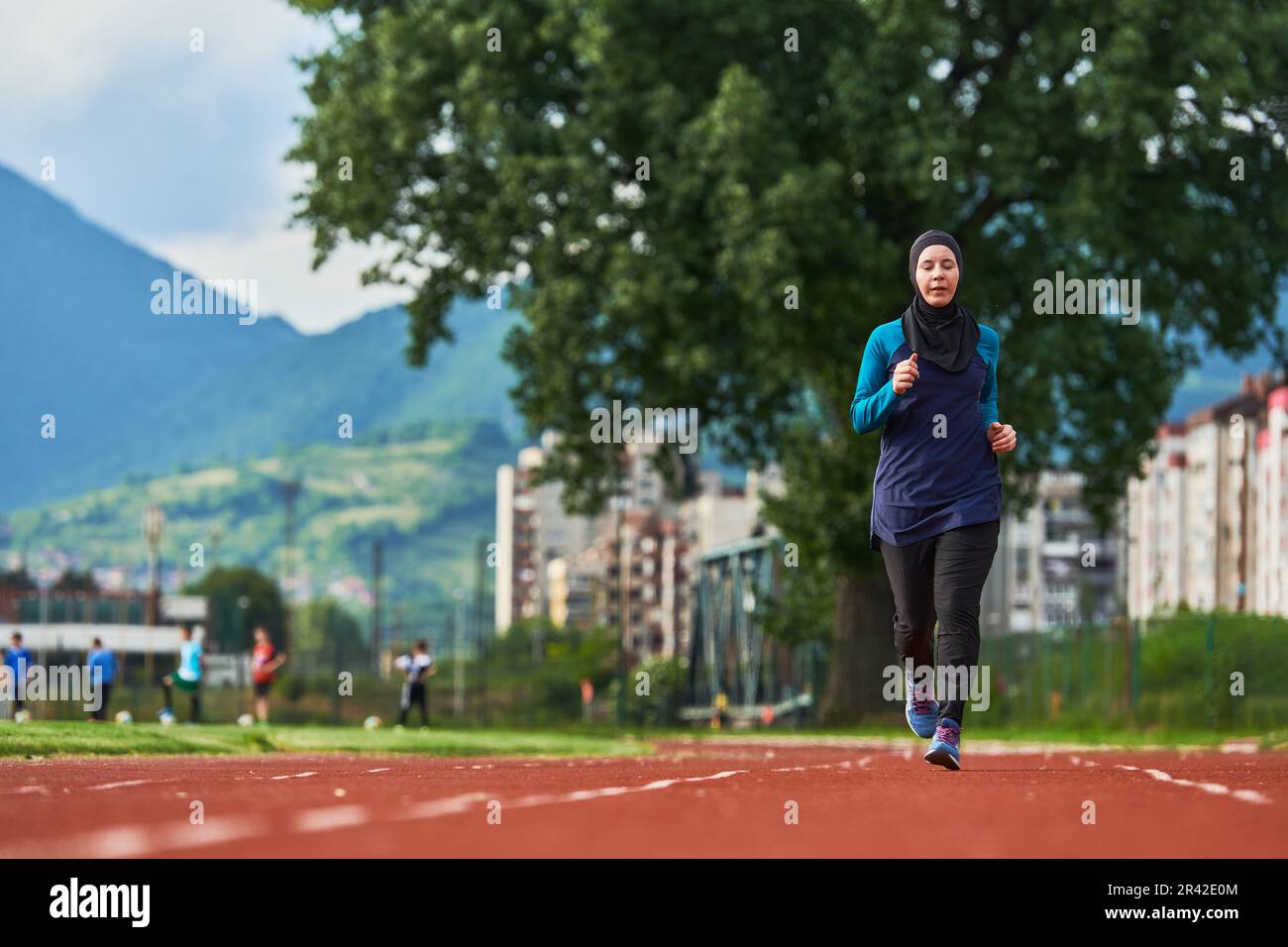 A muslim woman in a burqa sports muslim clothes running on a marathon ...
