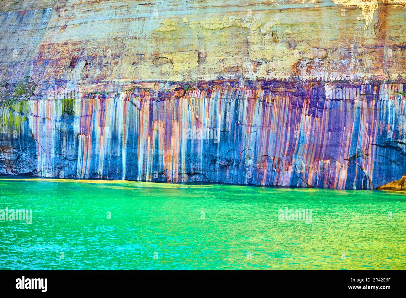 Turquoise, sea green lake water pressed against cliff walls of Pictured ...