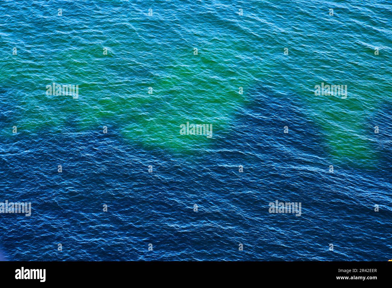 Deep blue waters with ripples on the surface featuring turquoise and ...