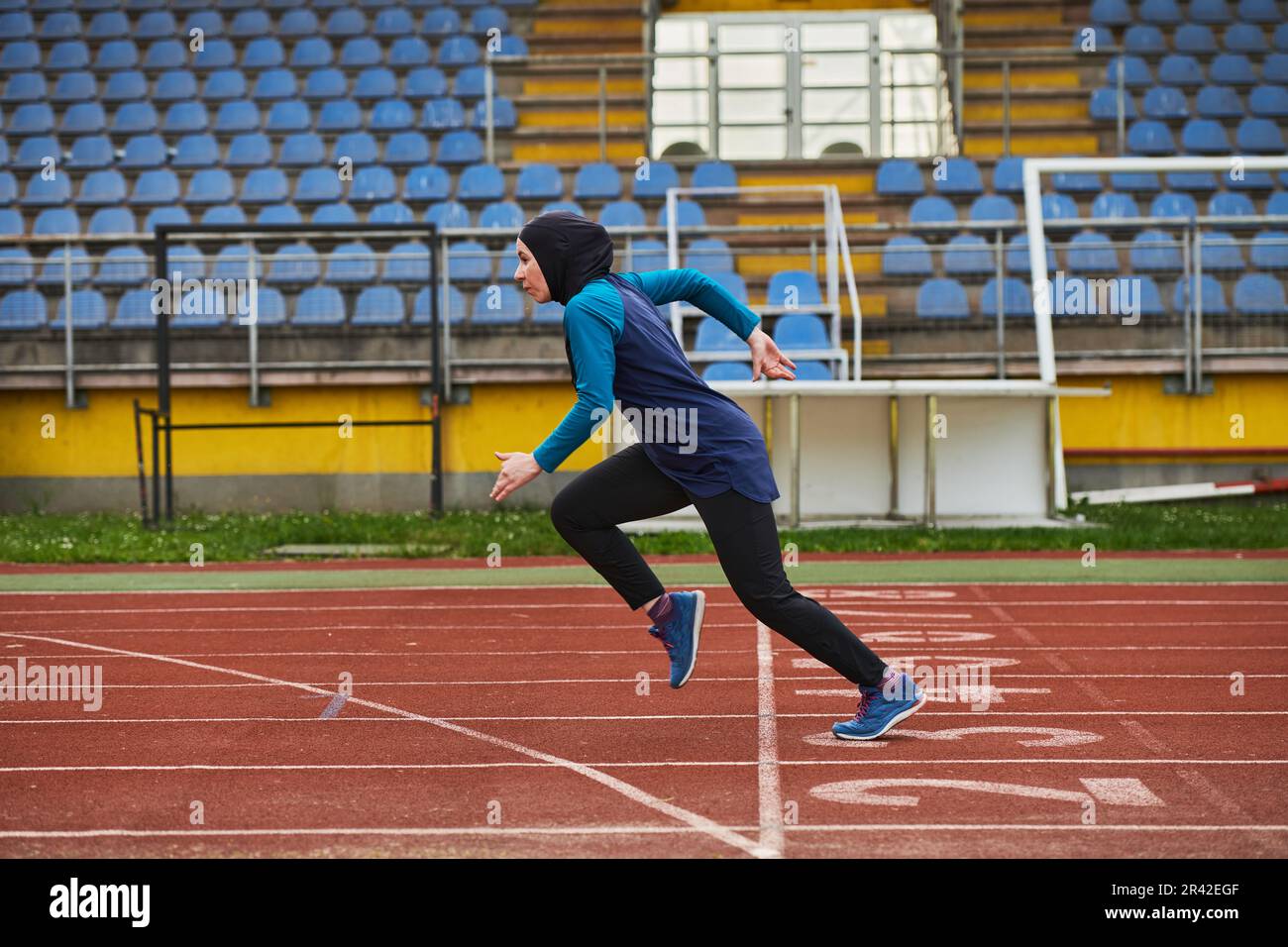 A muslim woman in a burqa sports muslim clothes running on a marathon ...